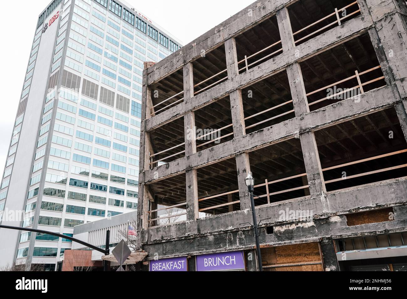 An old burned down building with a new office tower behind, a contrast ...
