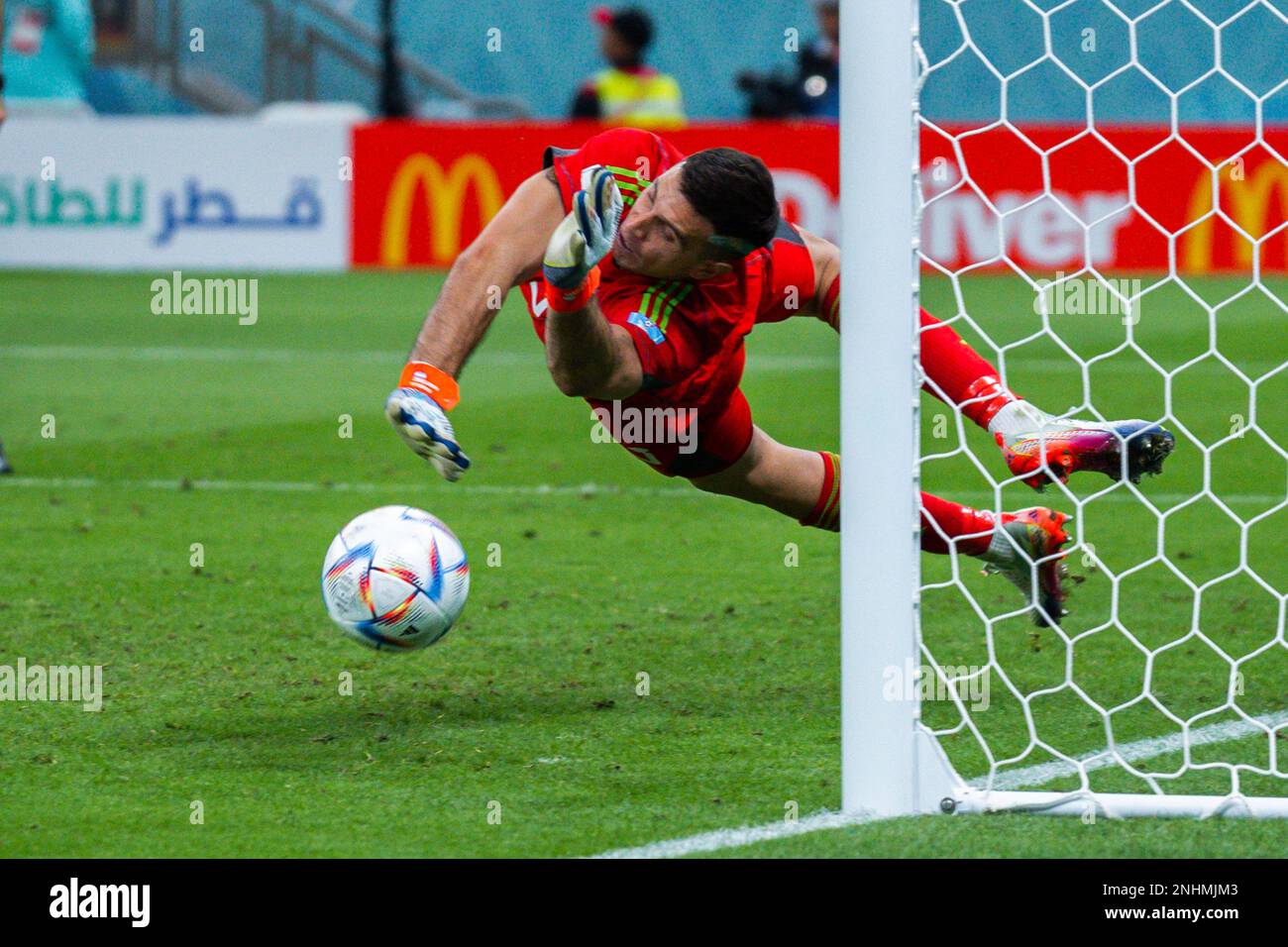 LUSAIL, - DECEMBER 09: Argentina goalkeeper Emiliano Martinez makes a ...