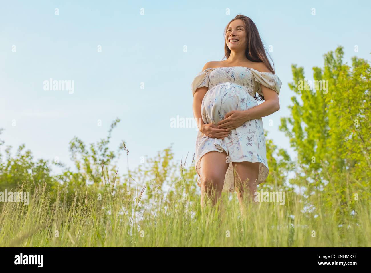 Pregnant woman holding showing belly baby bump happy and smilling full ...