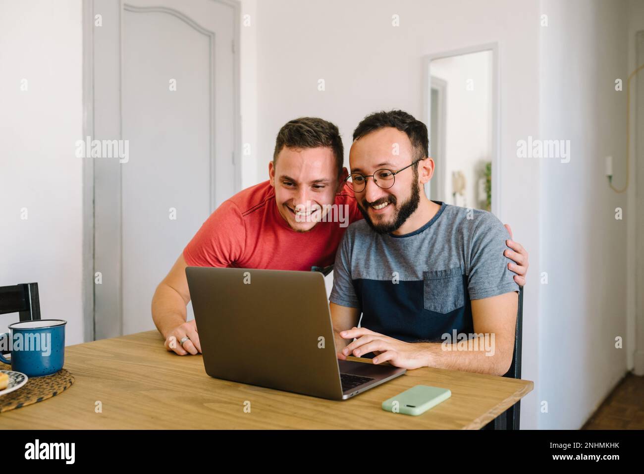 Two men looking at a laptop Stock Photo - Alamy