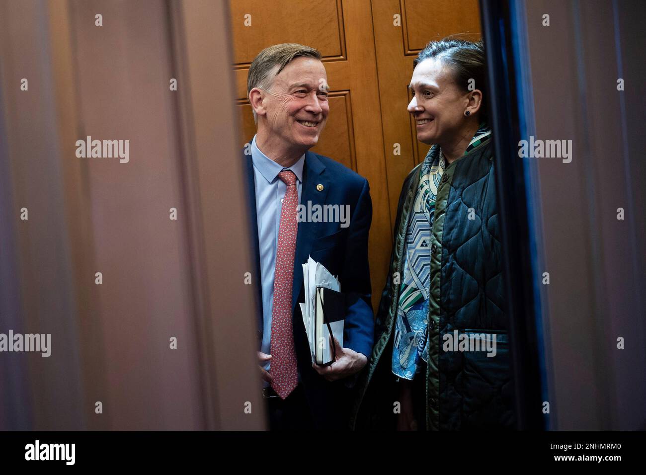 Sen. John Hickenlooper (D-Colo.) and his wife, Robin Pringle, board an ...