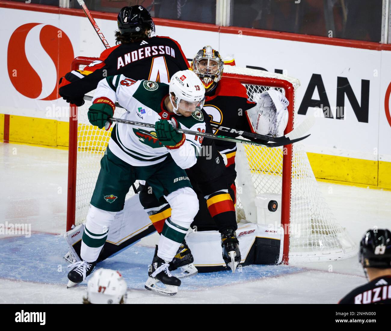 Minnesota Wild forward Sam Steel, center, checks Calgary Flames ...