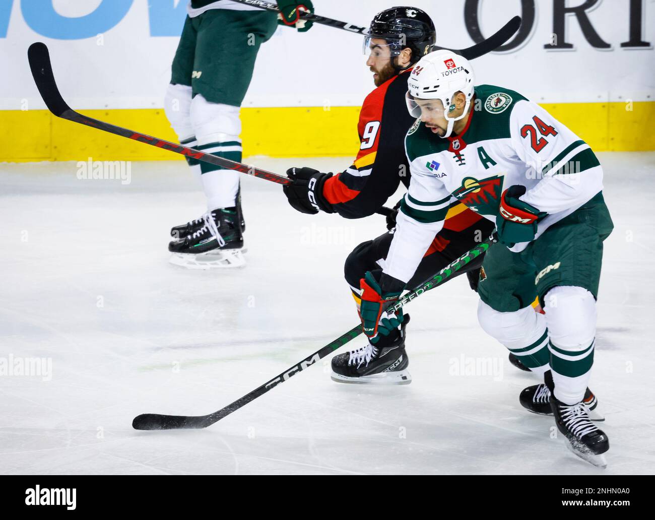 Minnesota Wild defenseman Matt Dumba, right, checks Calgary Flames ...