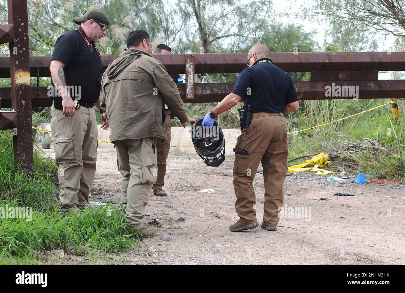 Border Patrol investigators lift the helmet worn by a border patrol ...