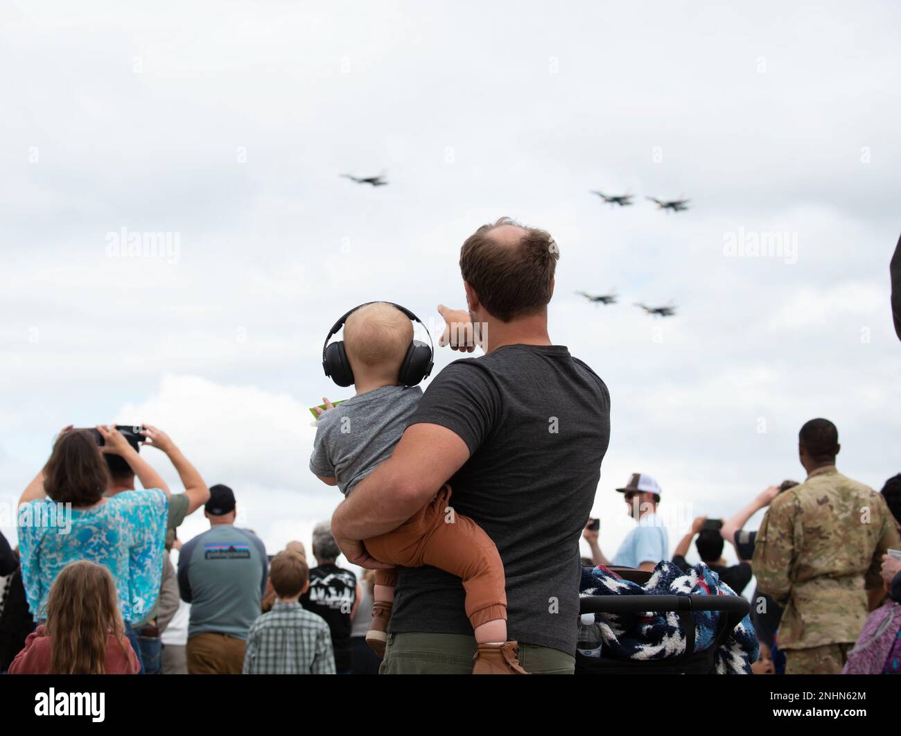 The crowd watches as the Thunderbirds fly overhead at the Arctic ...