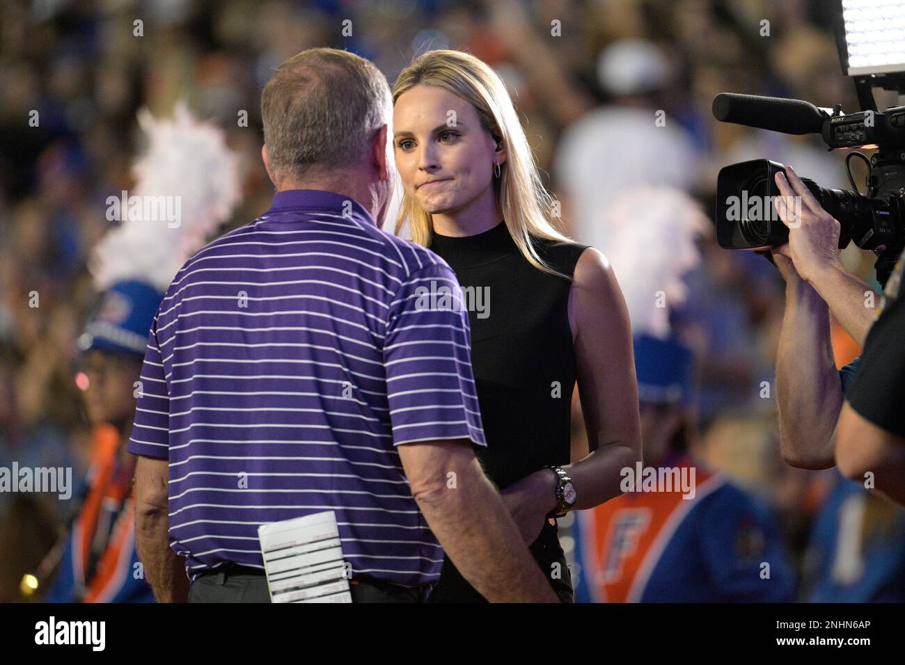 ESPN sideline reporter Katie George, center, interviews LSU head coach ...