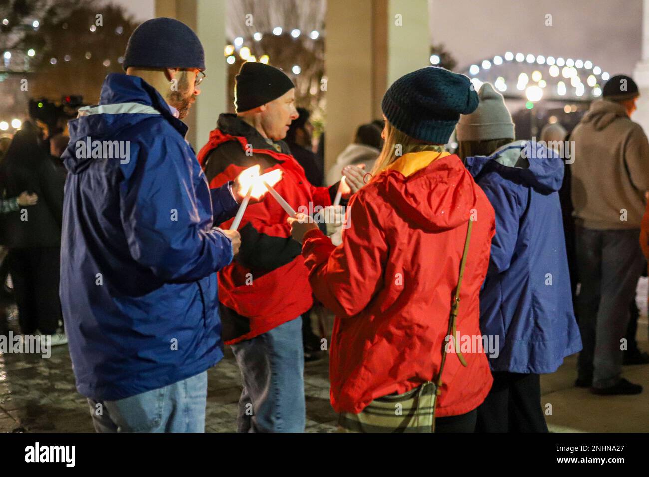 Family, friends, and members of the community attend a candlelight ...
