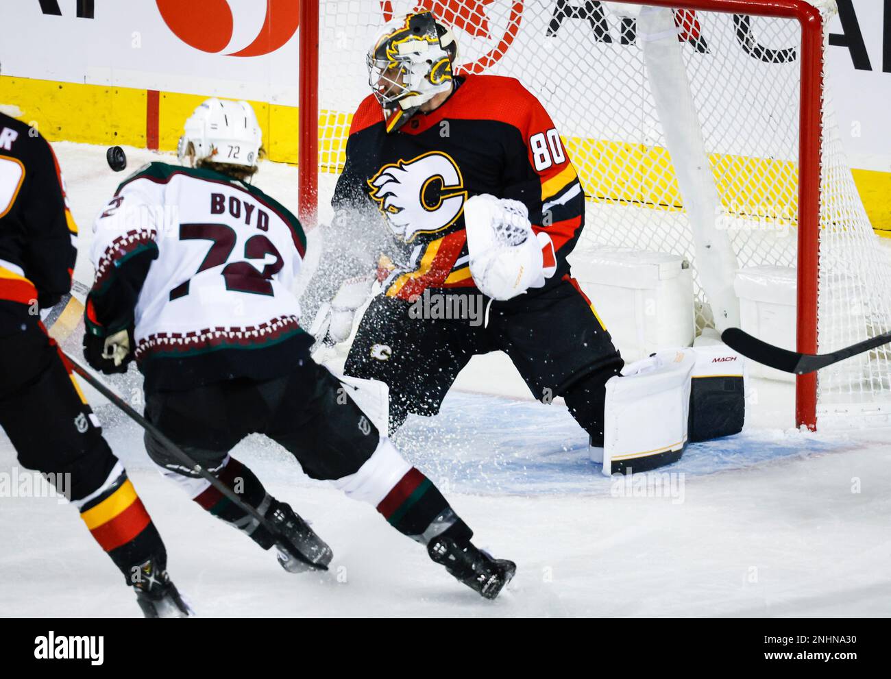 Arizona Coyotes forward Travis Boyd, left, chases a lose puck in front ...