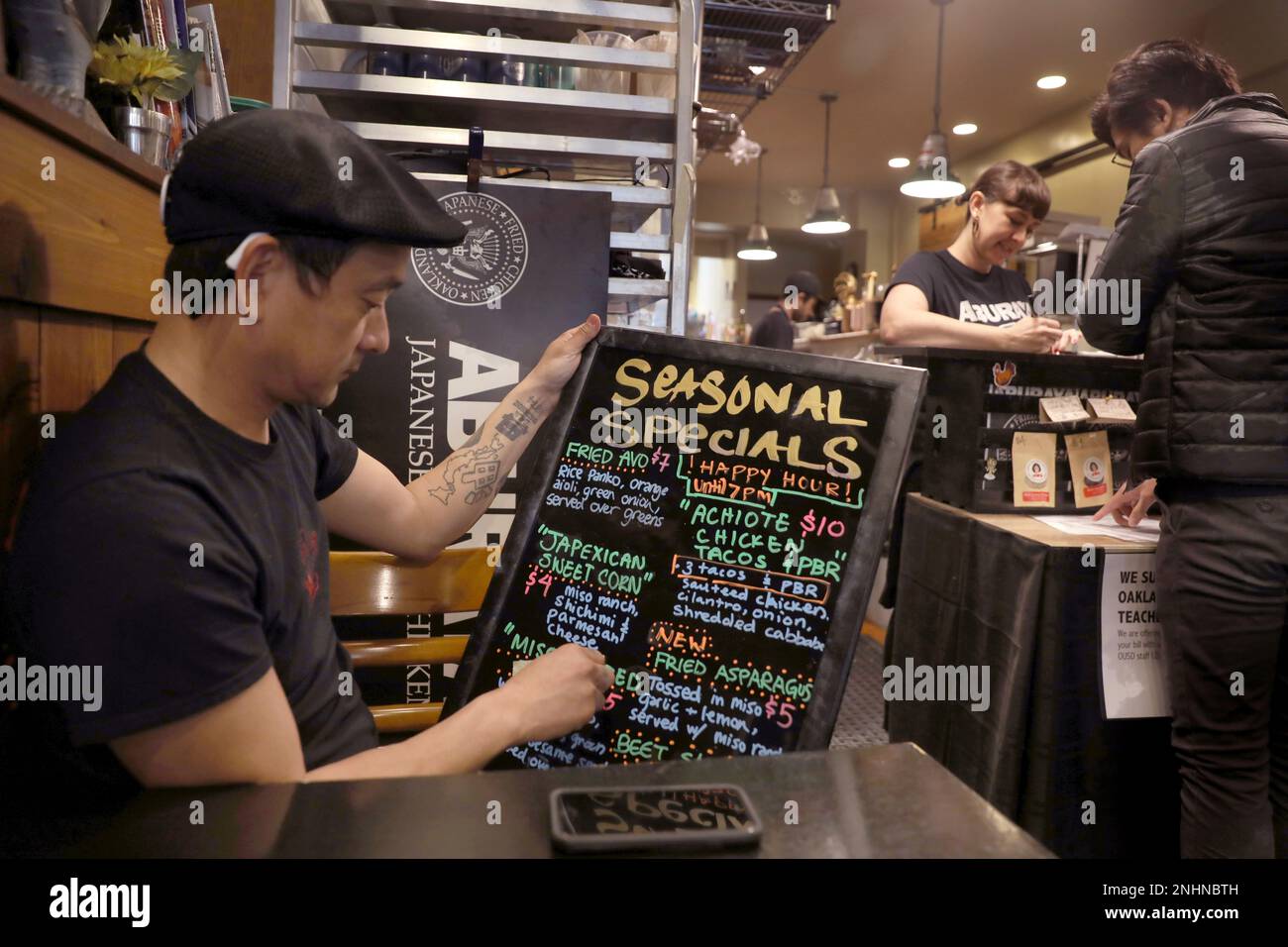 Founder Adachi Hiroyuki looks at the dinner menu with at Aburaya on ...