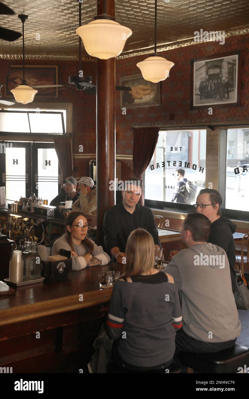 View of Homestead bar with manager Austin Hunt (middle) behind the bar ...