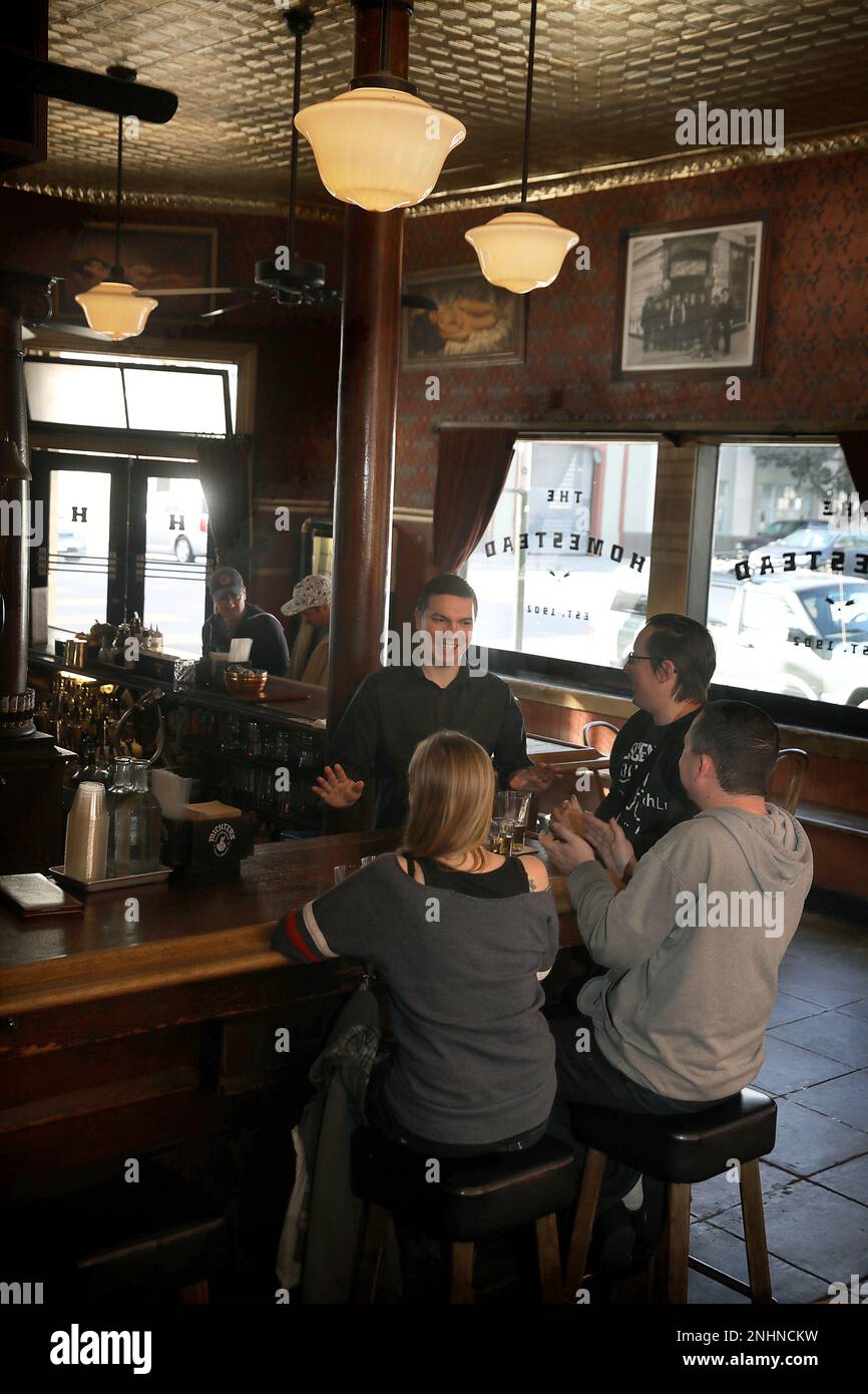 View of Homestead bar with manager Austin Hunt (middle) behind the bar ...