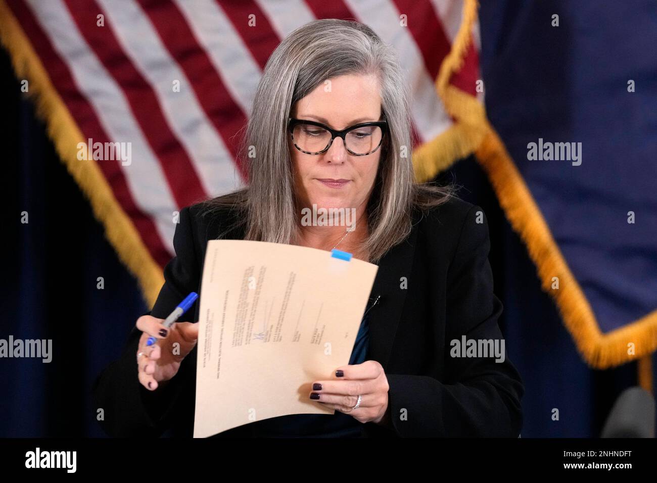 Katie Hobbs, the Democratic governor-elect and current secretary of state, signs the official ...