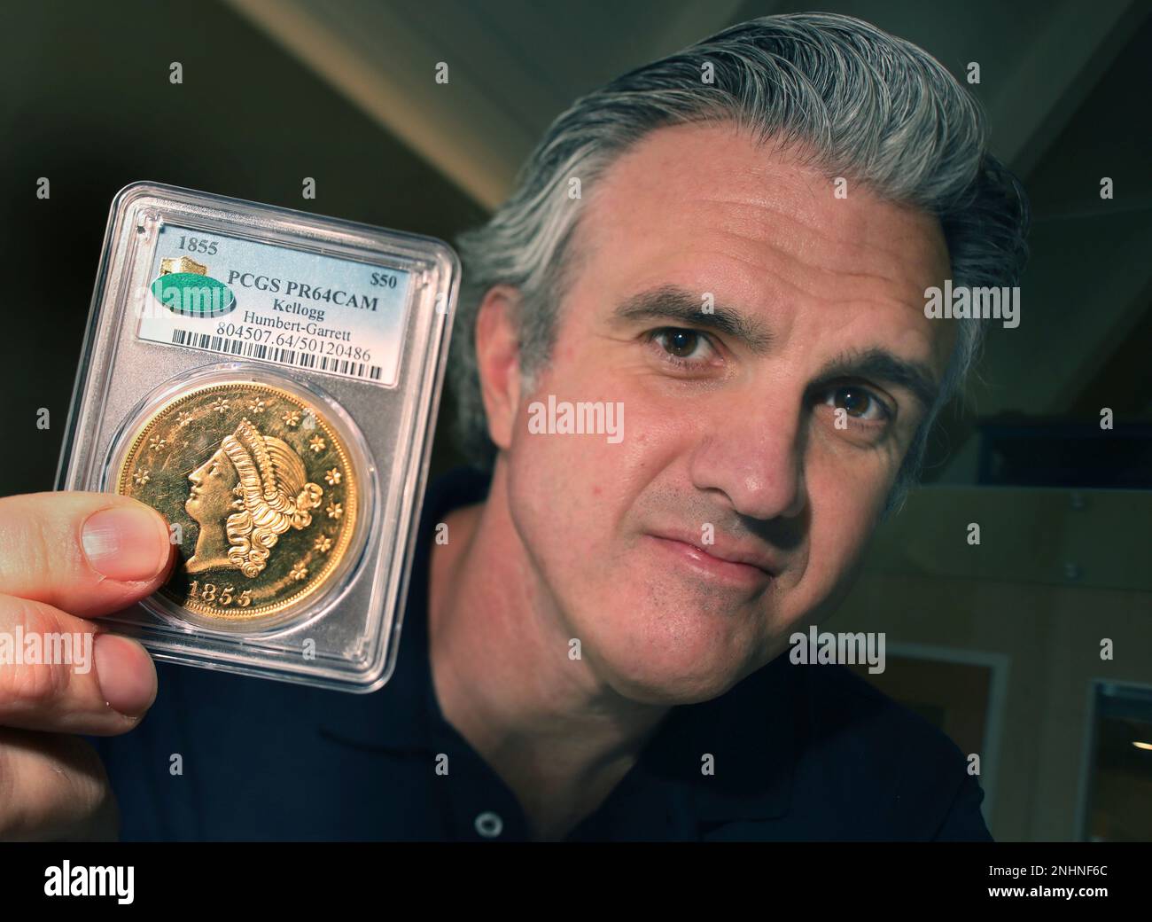 Store owner Seth Chandler shows a $1 million dollar California gold ...