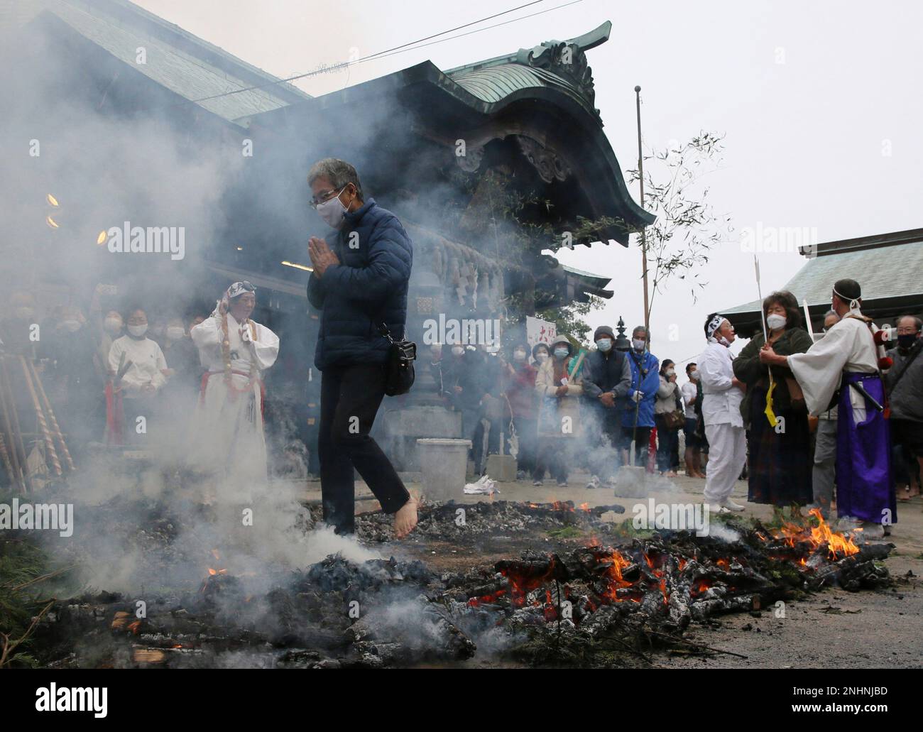 Worshippers walk barefoot on burning coals during a ritual ceremony at ...