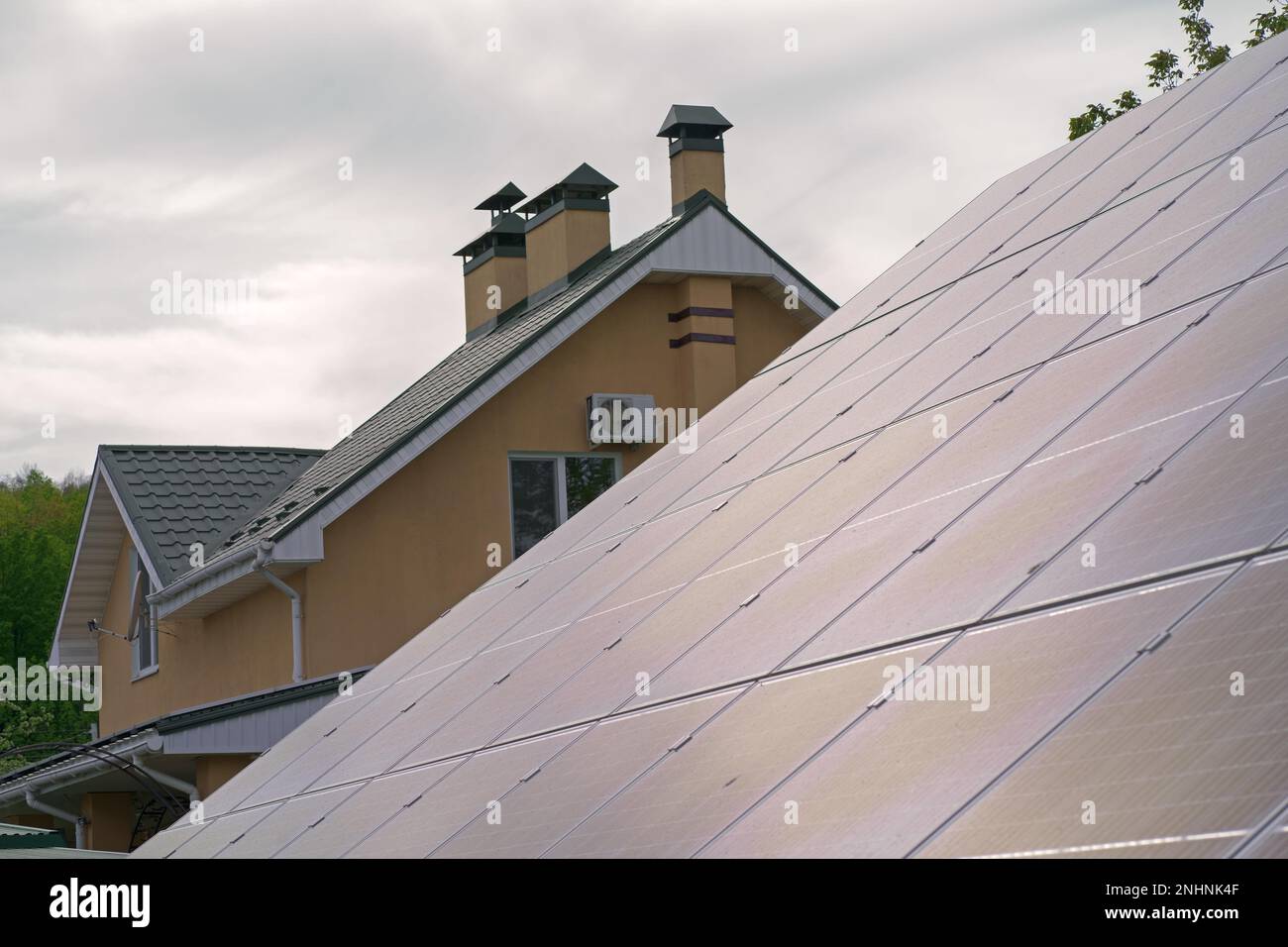 Close-up of solar panels installed on historic building gable roof with ...