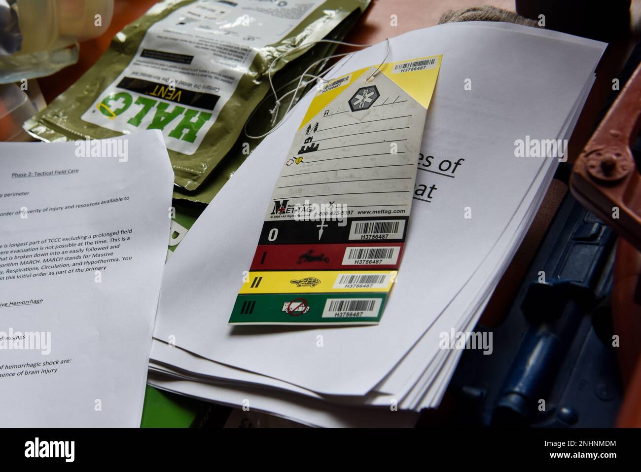 A triage tag sits on a table of props for Tactical Combat Casualty Care ...