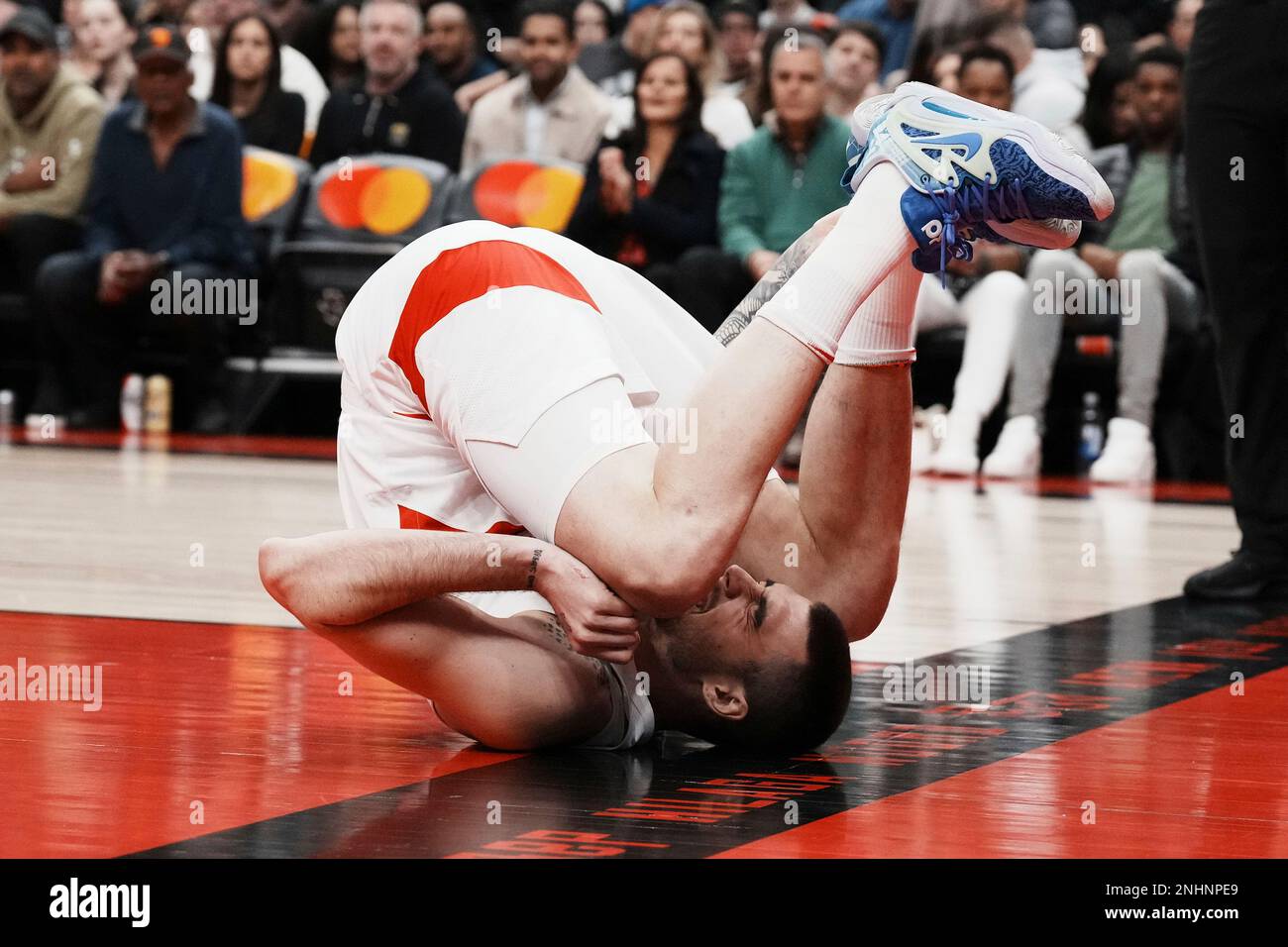 Toronto Raptors' Juancho Hernangomez clutches his ankle as he goes down ...