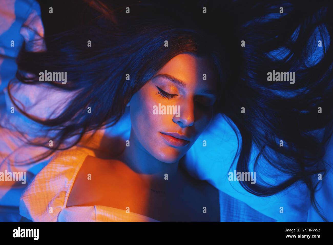 Sleeping, vaporwave lights and woman with eyes closed in bedroom with ...