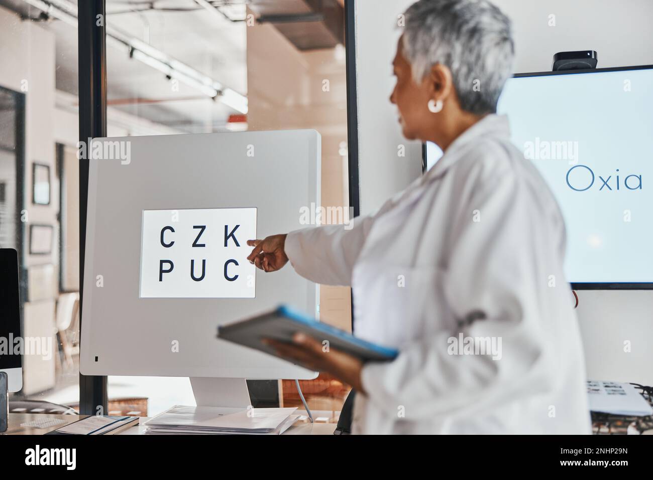 Letter eye exam, chart and senior woman doctor pointing to eyes test ...