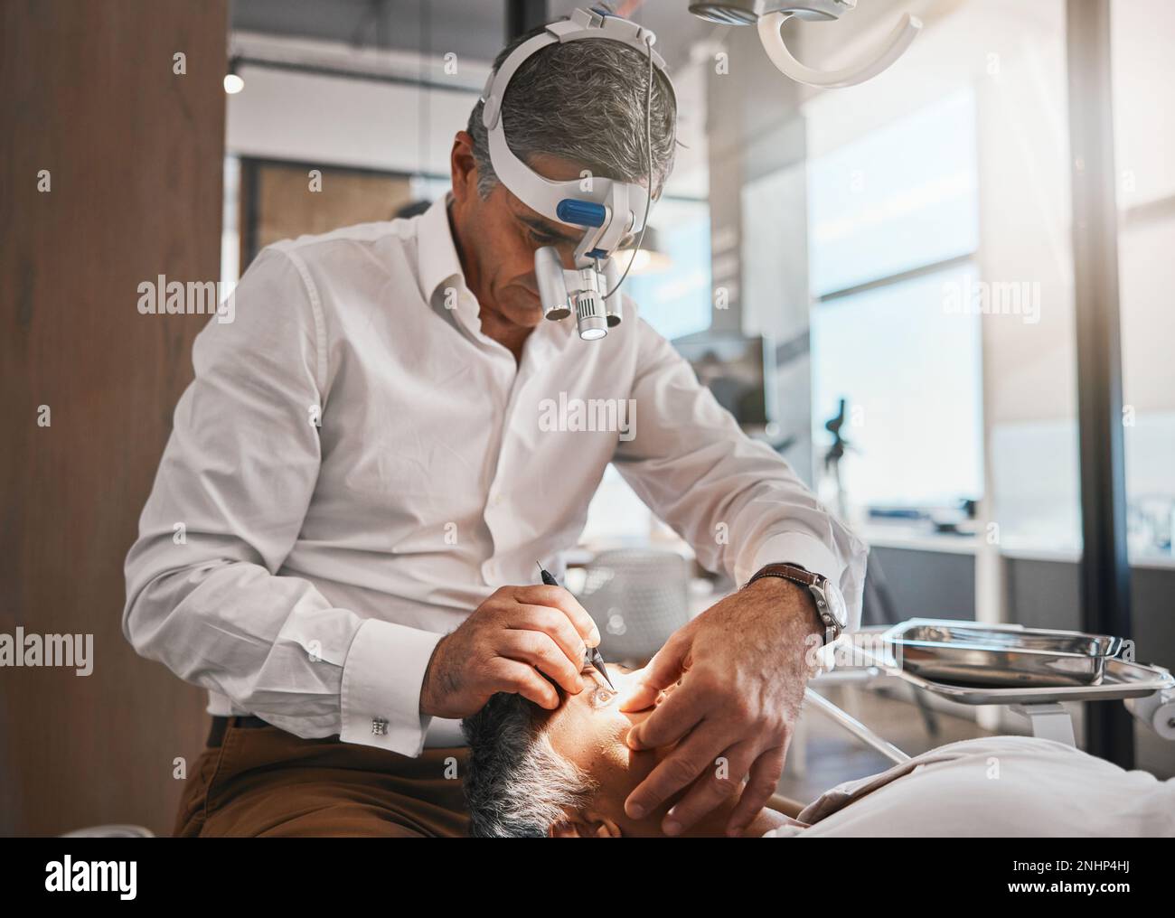 Healthcare, optometry and optometrist doing a cataract surgery on a ...