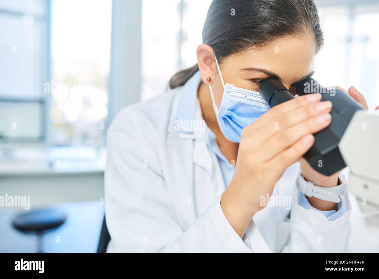 Exploring the many mysteries of science. a young scientist using a ...