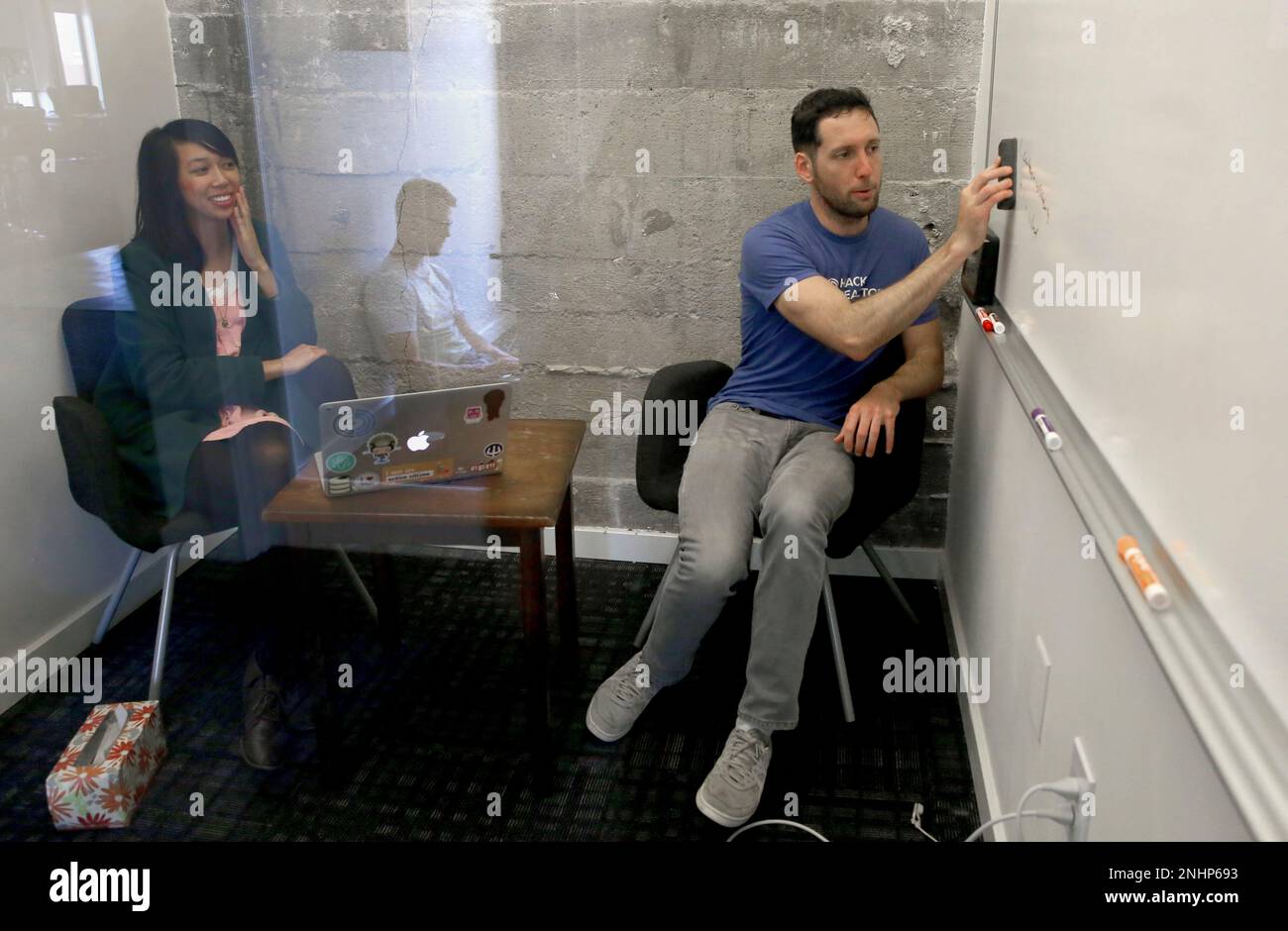 Class coordinator Jackie Ho (left) talks with chief commercial officer ...