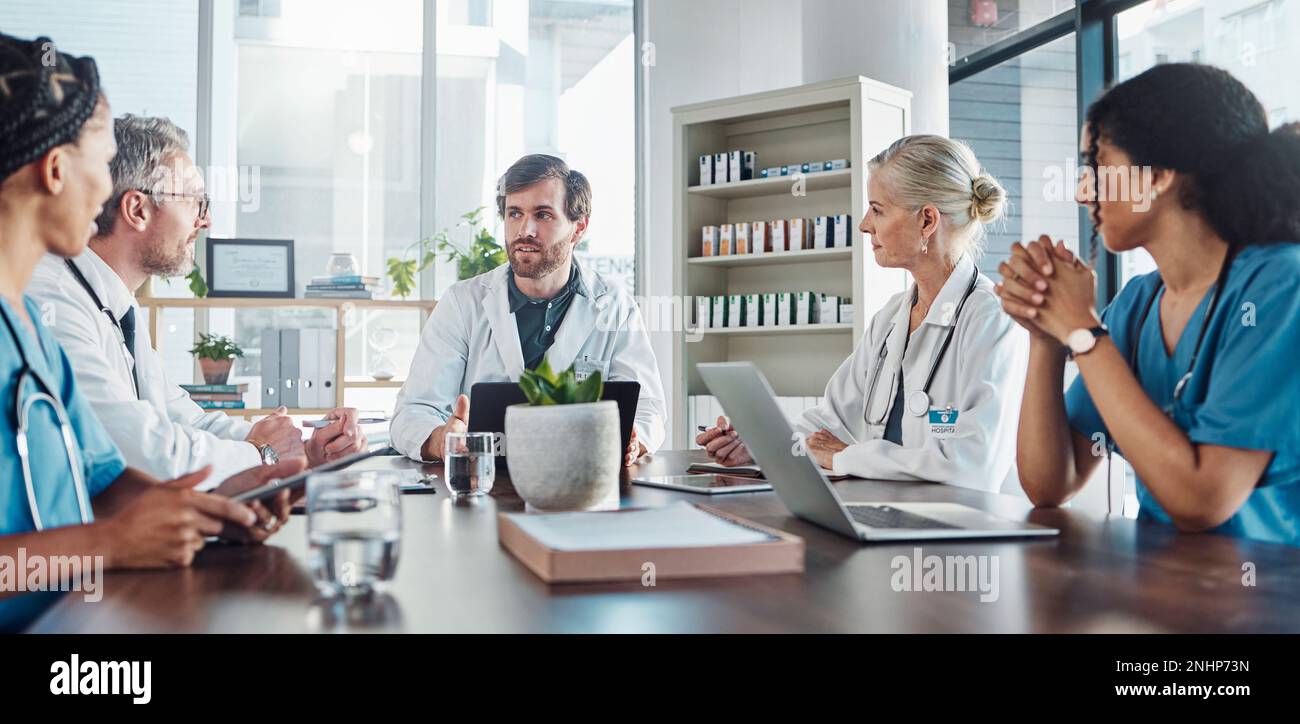 Multicultural Medical Team Having Meeting In Hospital Corridor Stock