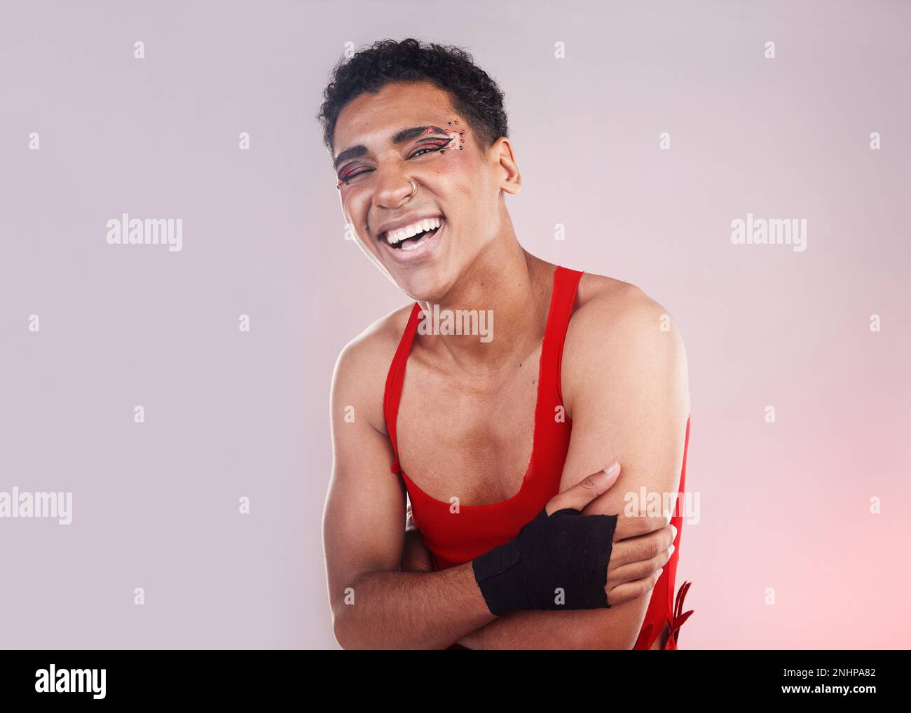 Creative, punk and portrait of man in studio, happy and laughing ...