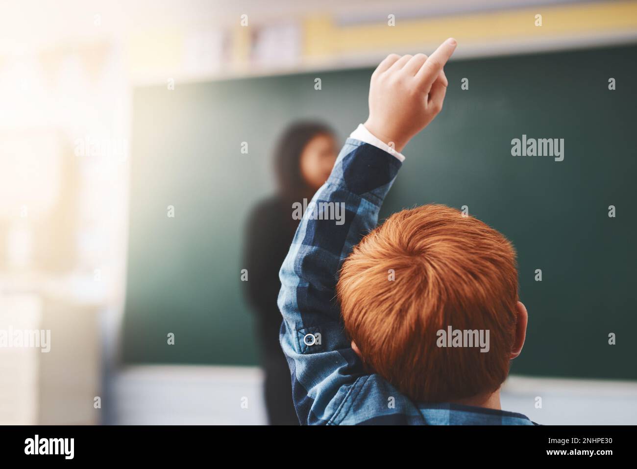 Pick me. elementary school children raising their hands to ask ...
