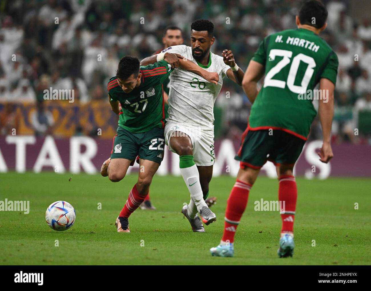 Mexico's Hirving LOZANO and Saudi Arabia's RIYADH SHARAHILI struggle to hold a ball during the ...