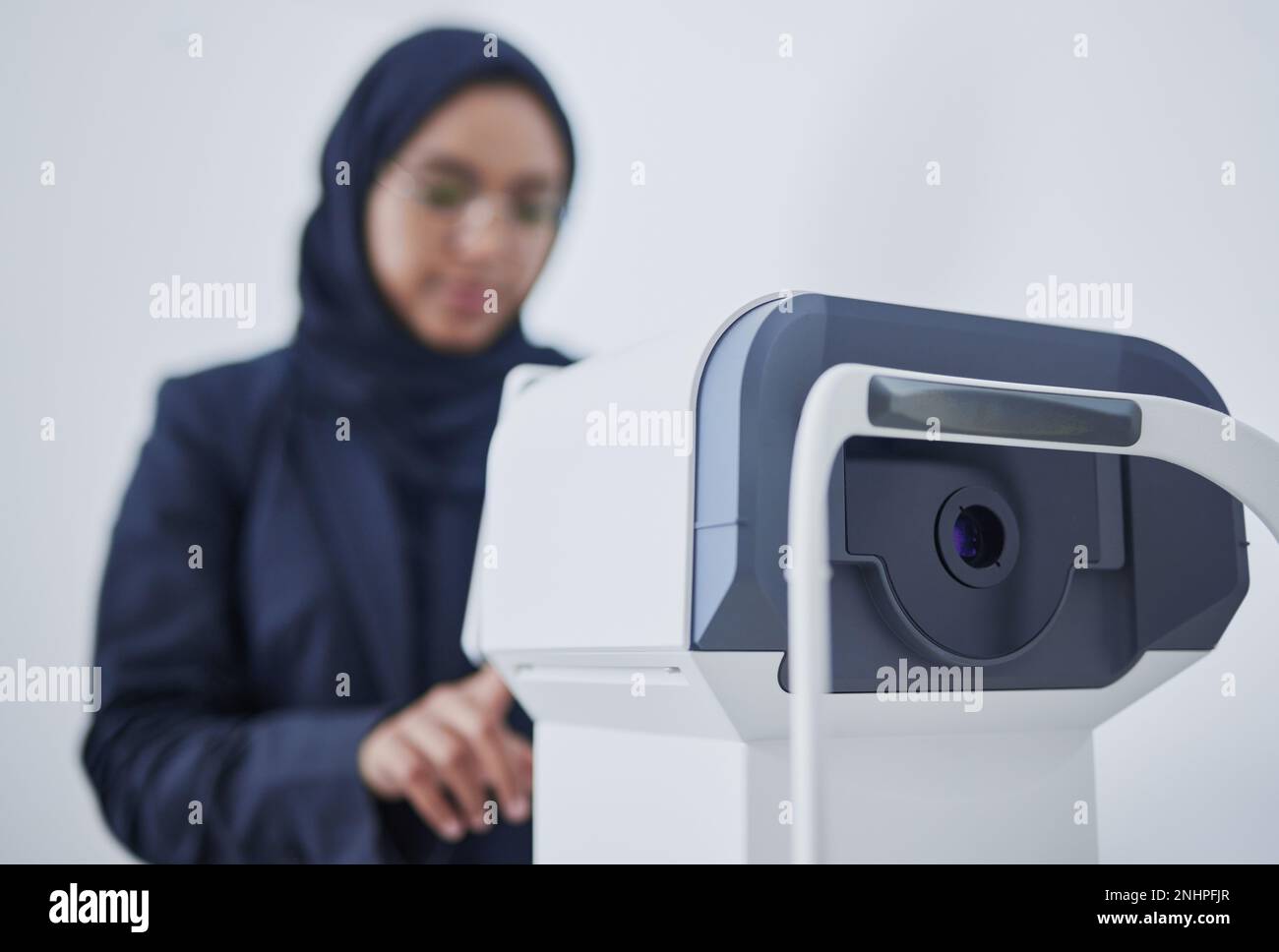 Optometry, ophthalmology and Muslim woman with a machine for vision ...