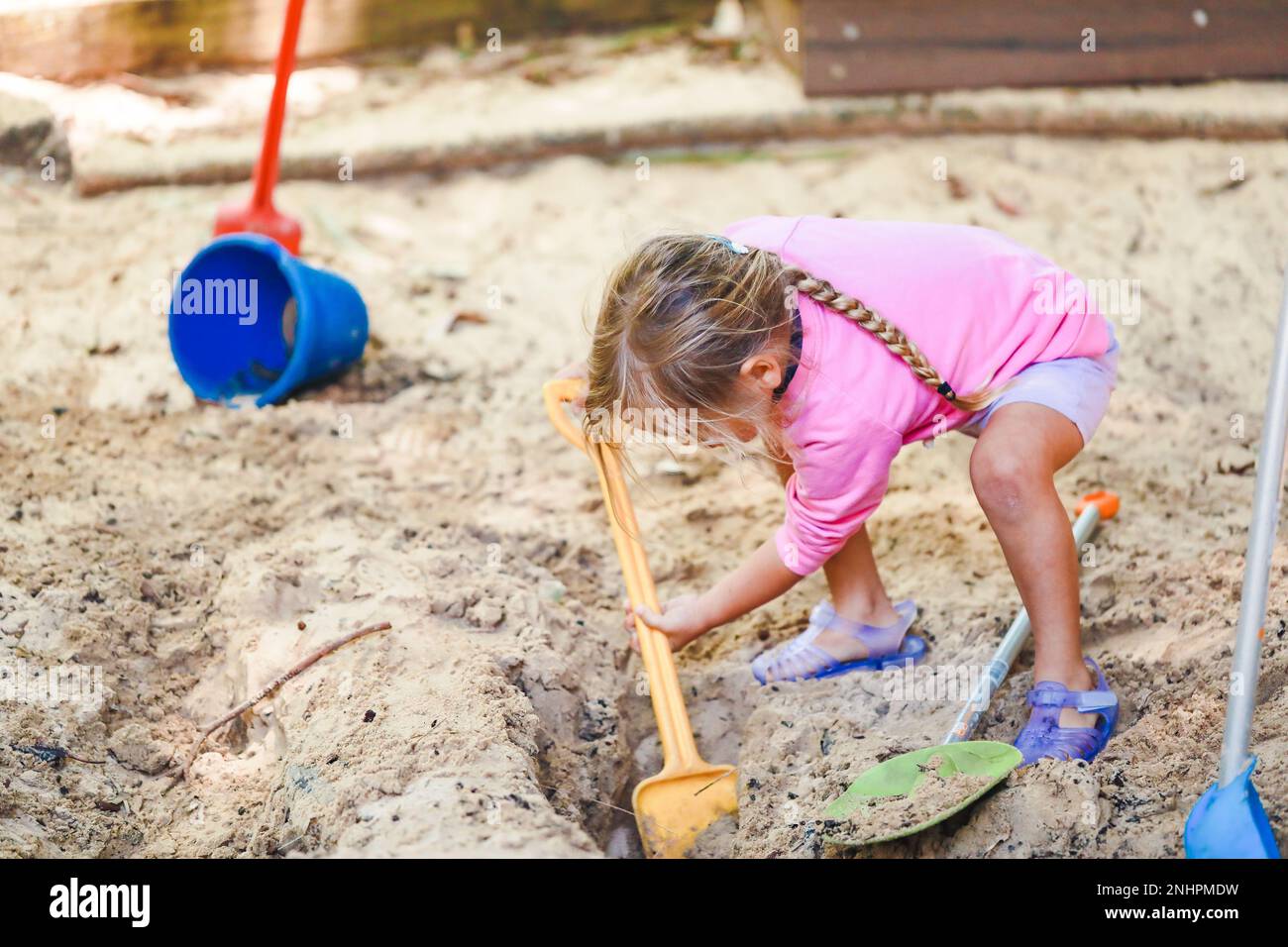 Little girl is playing in the sandpit hi-res stock photography and ...