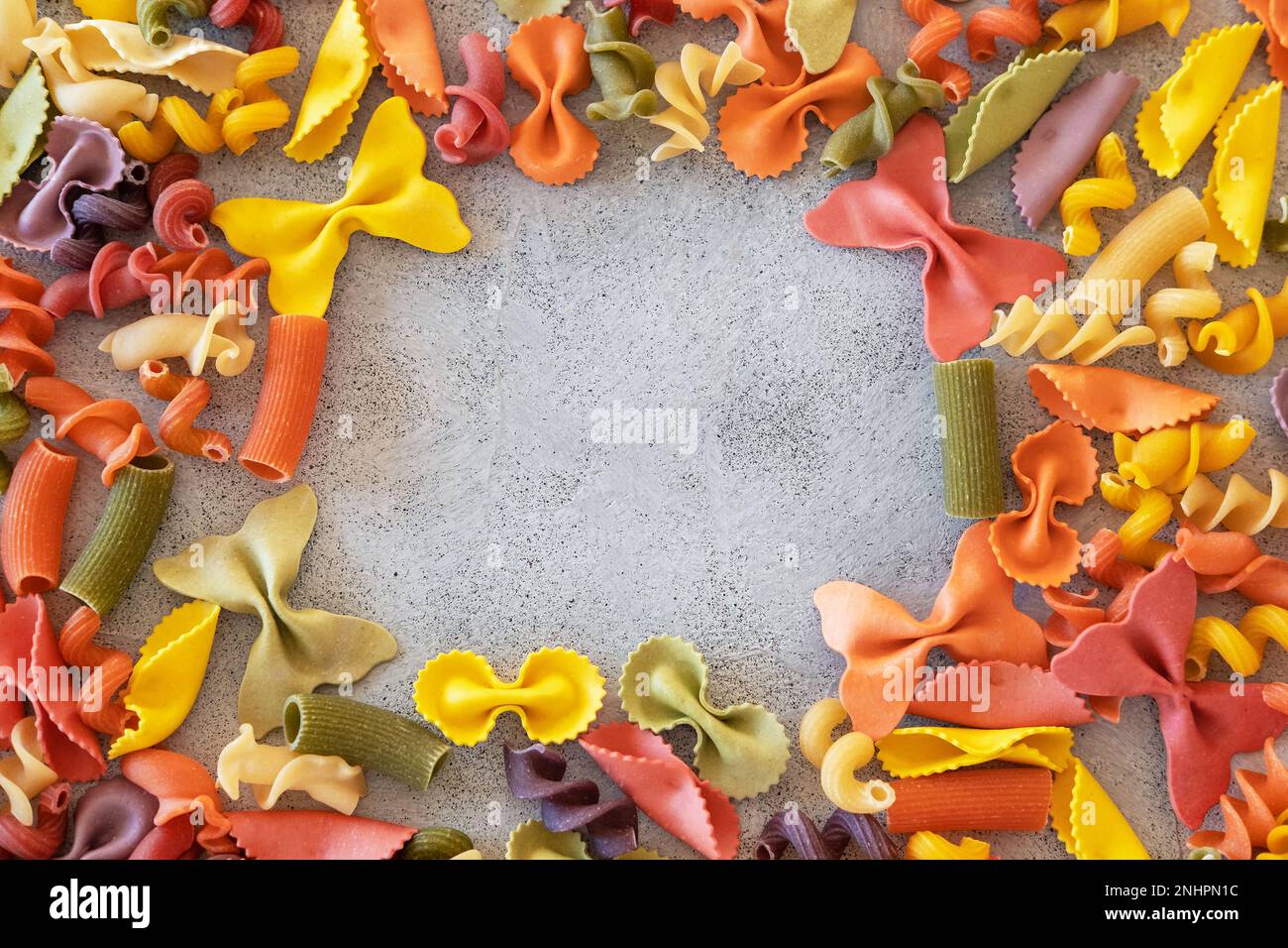 Variety of types and shapes of Italian pasta on concrete background ...