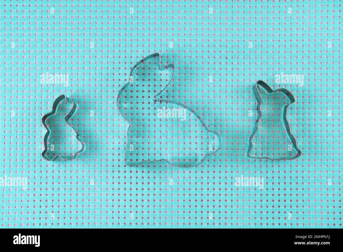 Easter cookie cutters in the shape of bunny on blue background, top ...