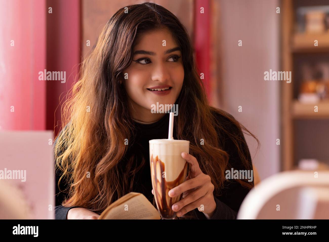 Young woman drinking coffee front cafe hi-res stock photography and ...