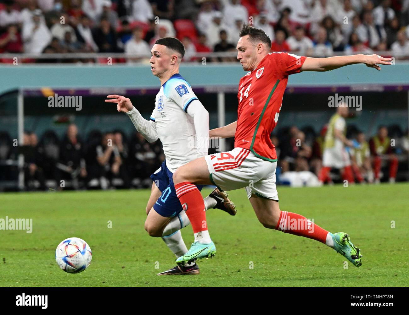 Wales' Connor ROBERTS and England's Phil FODEN struggle to hold a ball ...