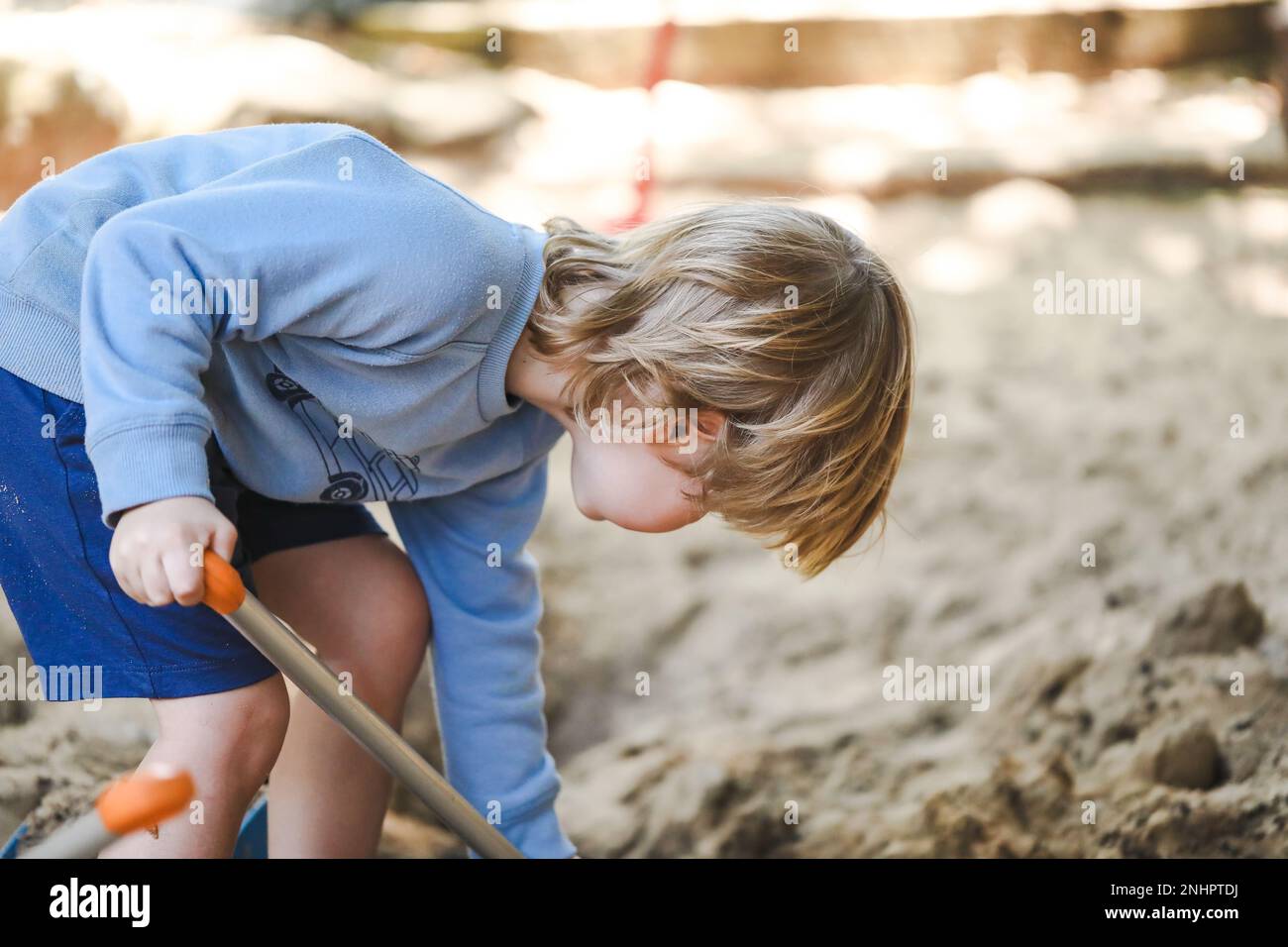 Little boy digging with shovel in sandpit at kindergarten Stock Photo ... Little boy digging with shovel in sandpit at kindergarten Stock Photo ...