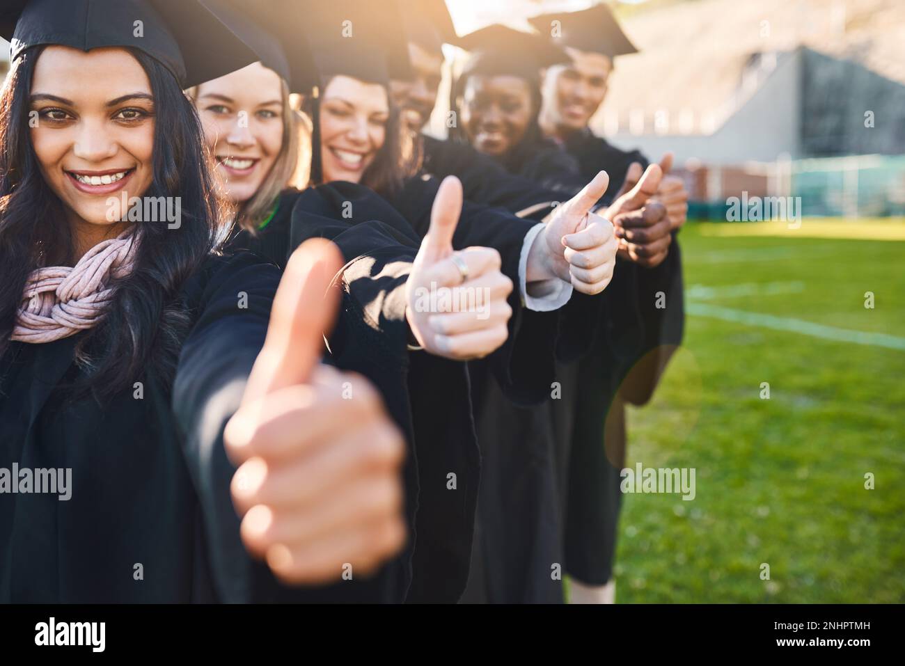 Say yes to the future. Portrait of a group of students showing thumbs ...