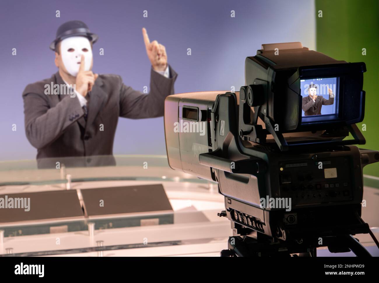 An unidentified man with a mask shows a gesture for silence to the ...