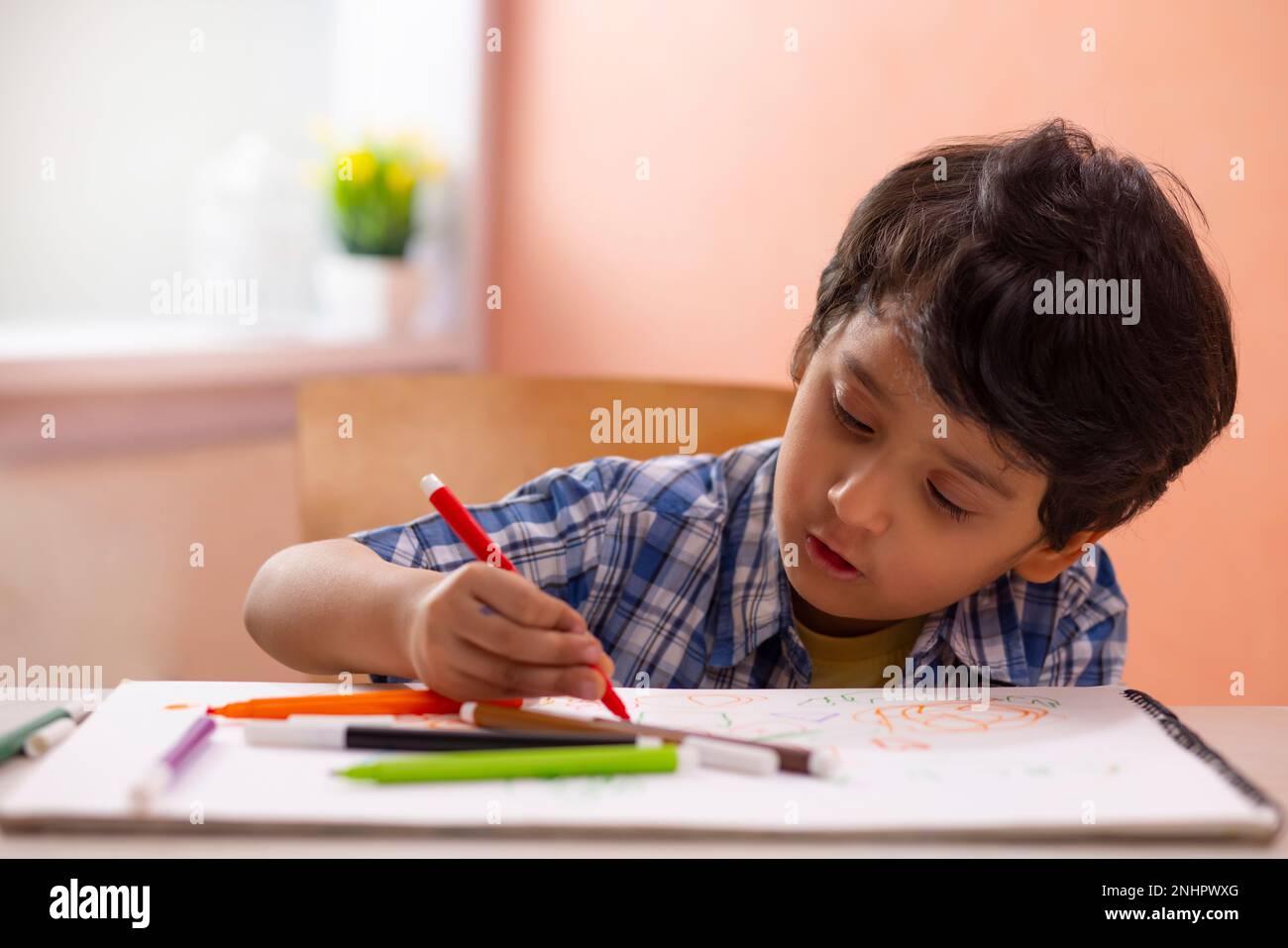 Portrait of a little boy drawing with colour pencil Stock Photo - Alamy