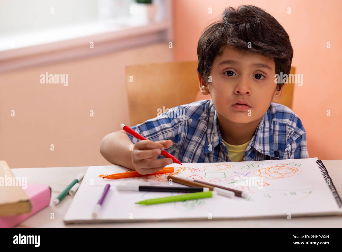 Portrait of a little boy drawing with colour pencil Stock Photo - Alamy