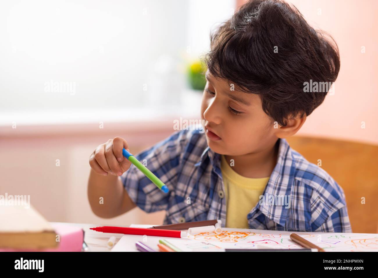 Portrait of a little boy drawing with colour pencil Stock Photo - Alamy