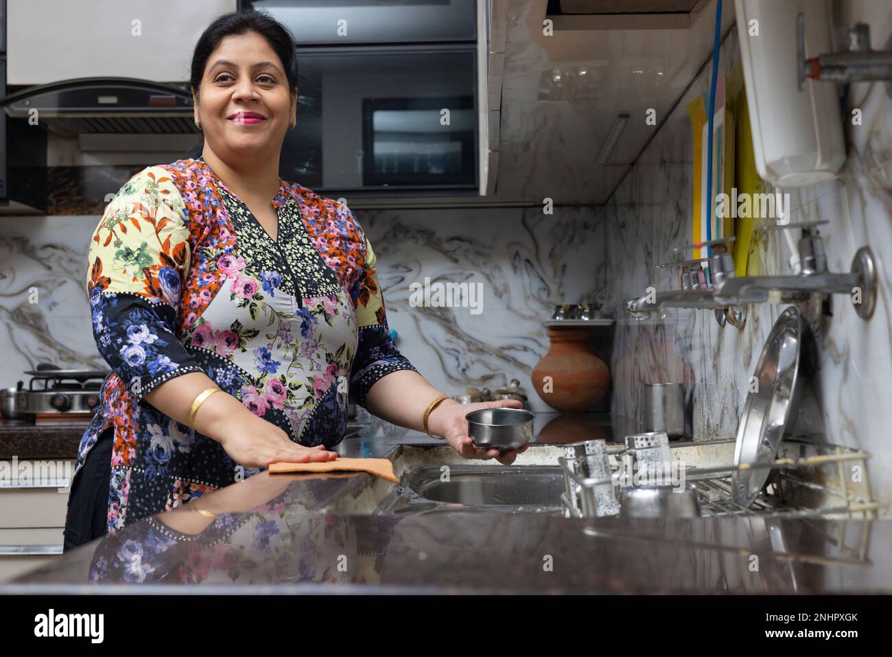 Woman washing utensil in hi-res stock photography and images - Alamy