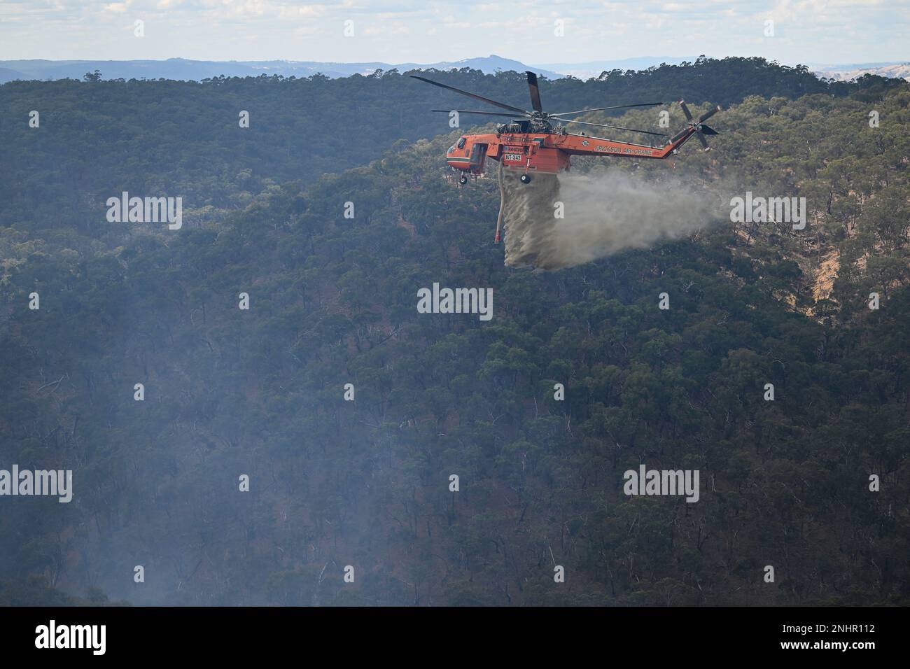 A firefighting aircraft works to extinguish flare ups in Flowerdale ...