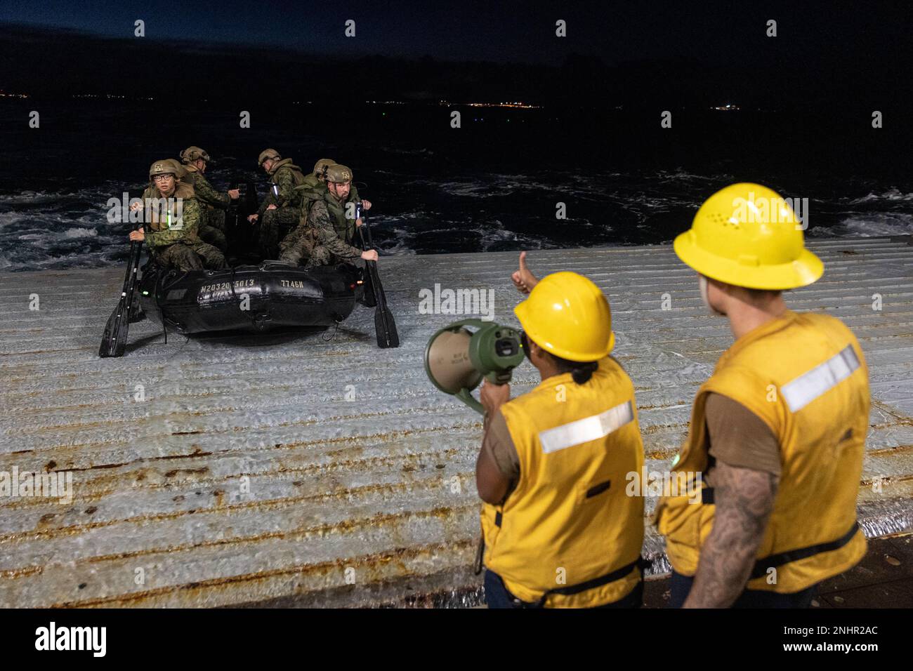 A U.S. Navy Sailor assigned to USS New Orleans (LPD 18) signals to U.S ...