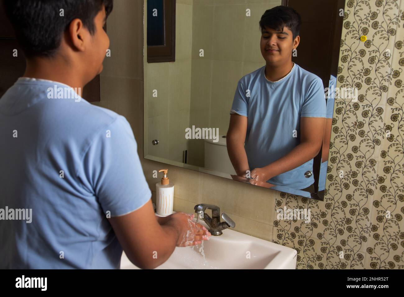 Portrait of boy washing hands in bathroom sink Stock Photo - Alamy