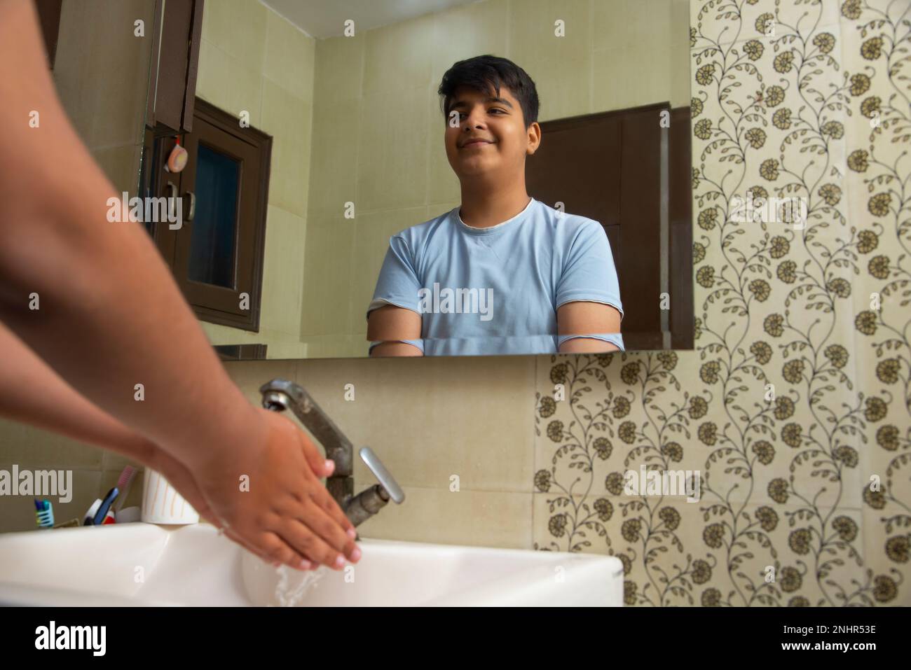 Portrait of boy washing hands in bathroom sink Stock Photo - Alamy