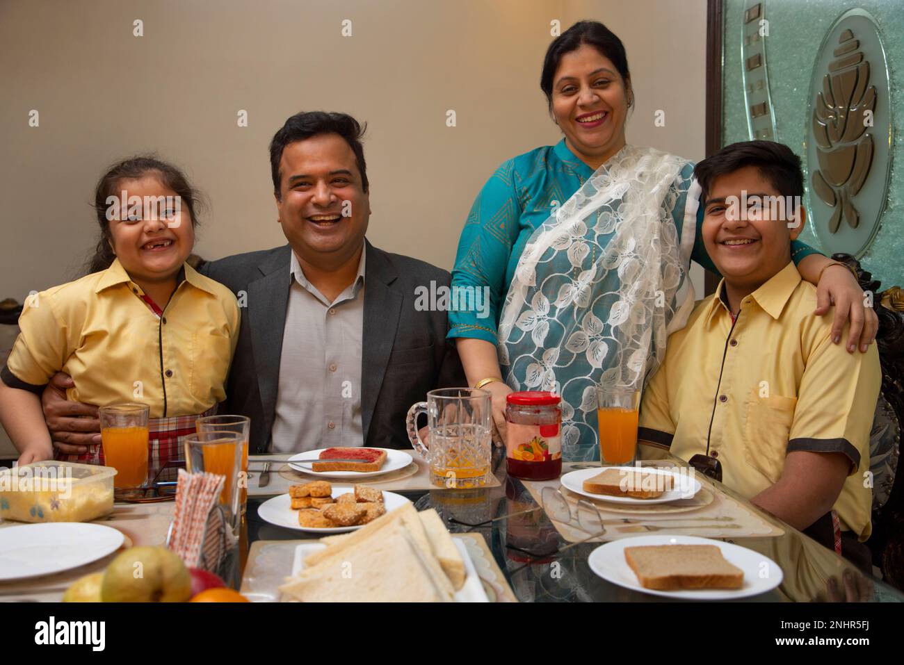 Portrait of happy middle class family together at home during breakfast ...