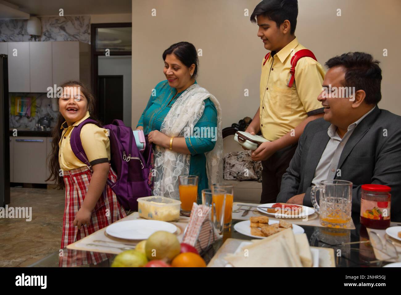 Mother giving lunch box to her daughter before school Stock Photo - Alamy