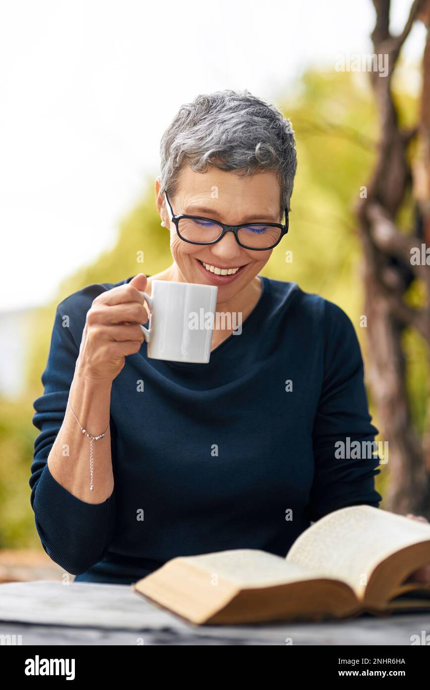 Her idea of the perfect day. an attractive senior woman reading her ...